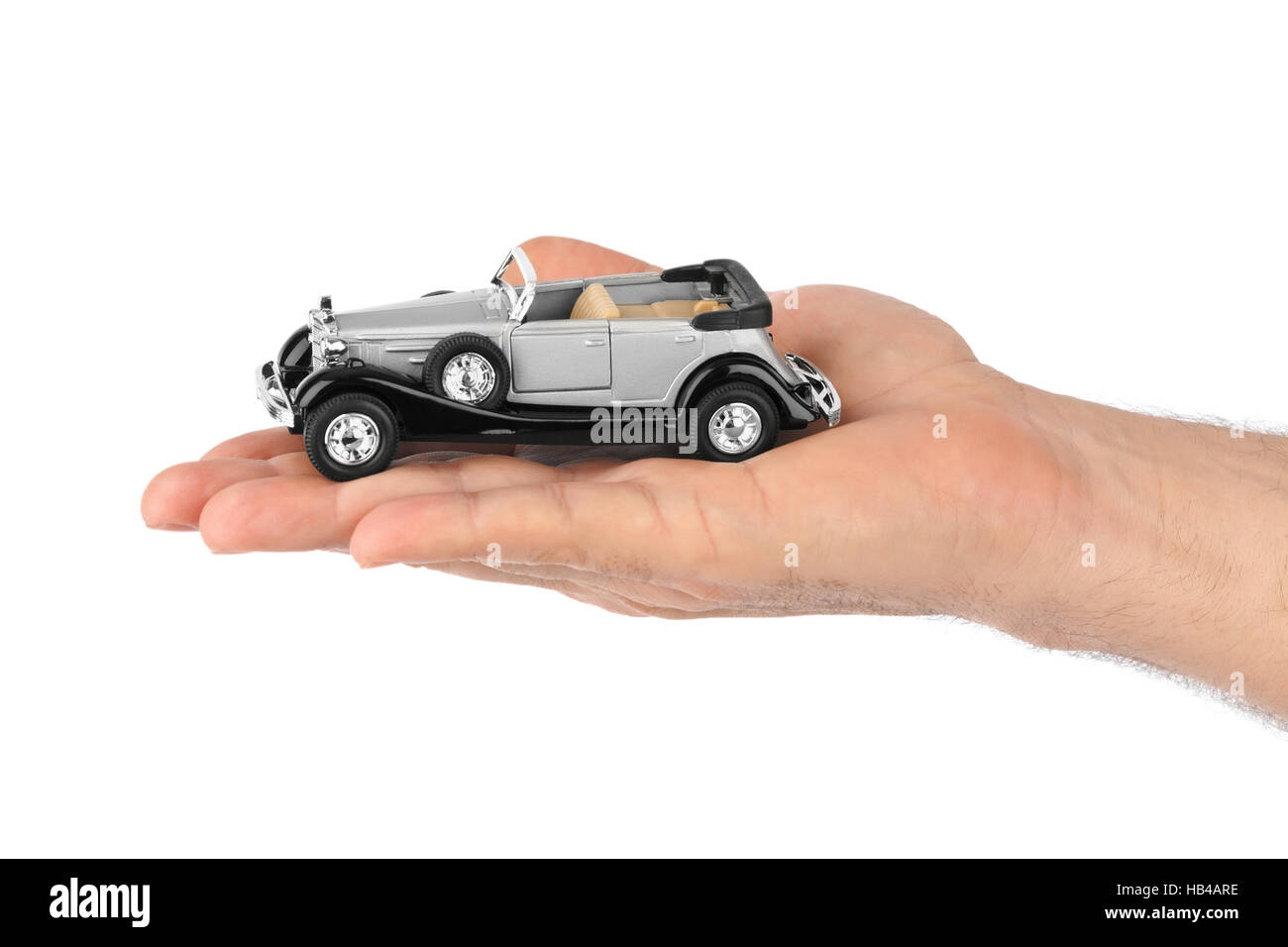 Hand with retro car Stock Photo - Alamy