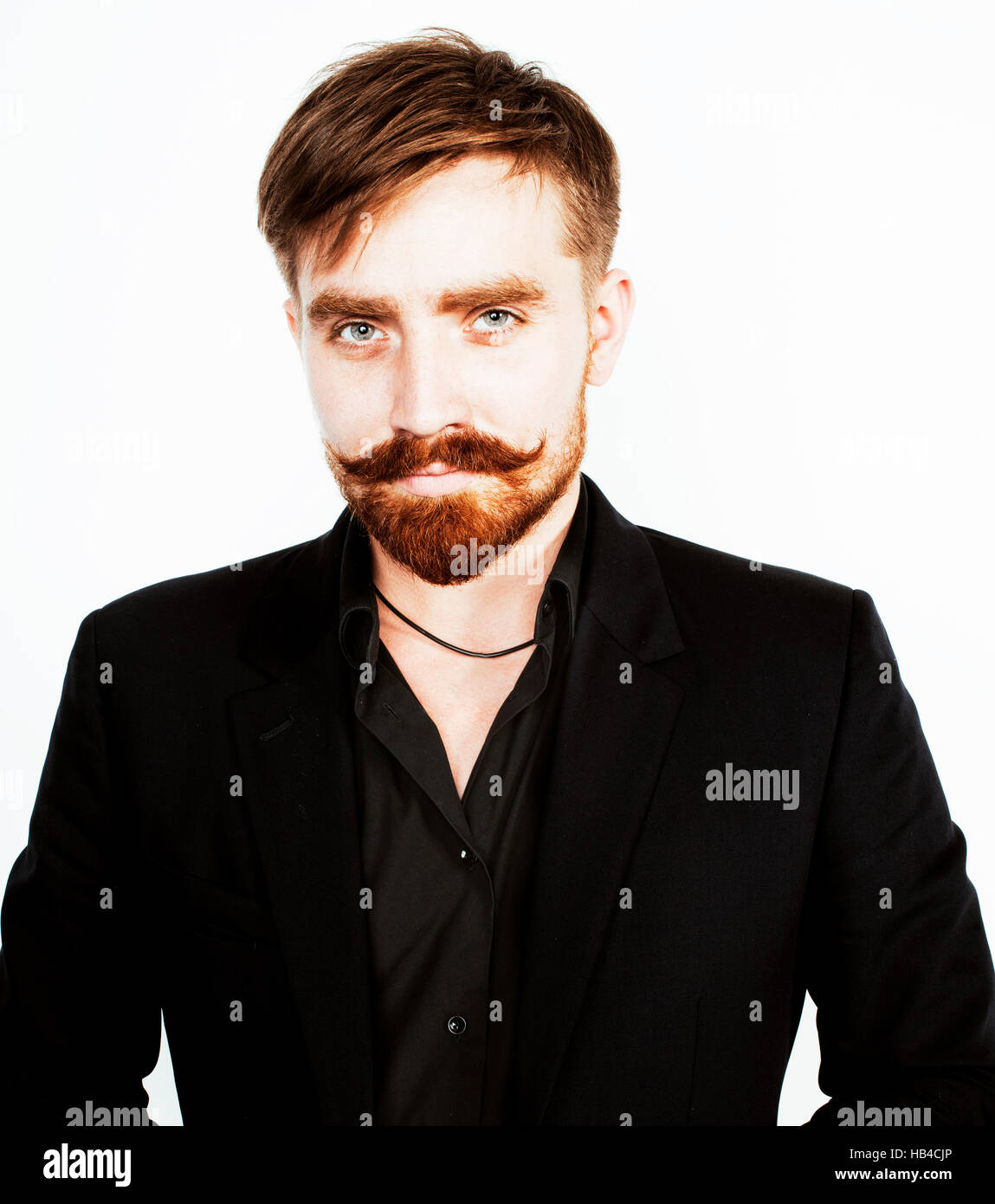 young red hair man with beard and mustache in black suit on whit Stock ...