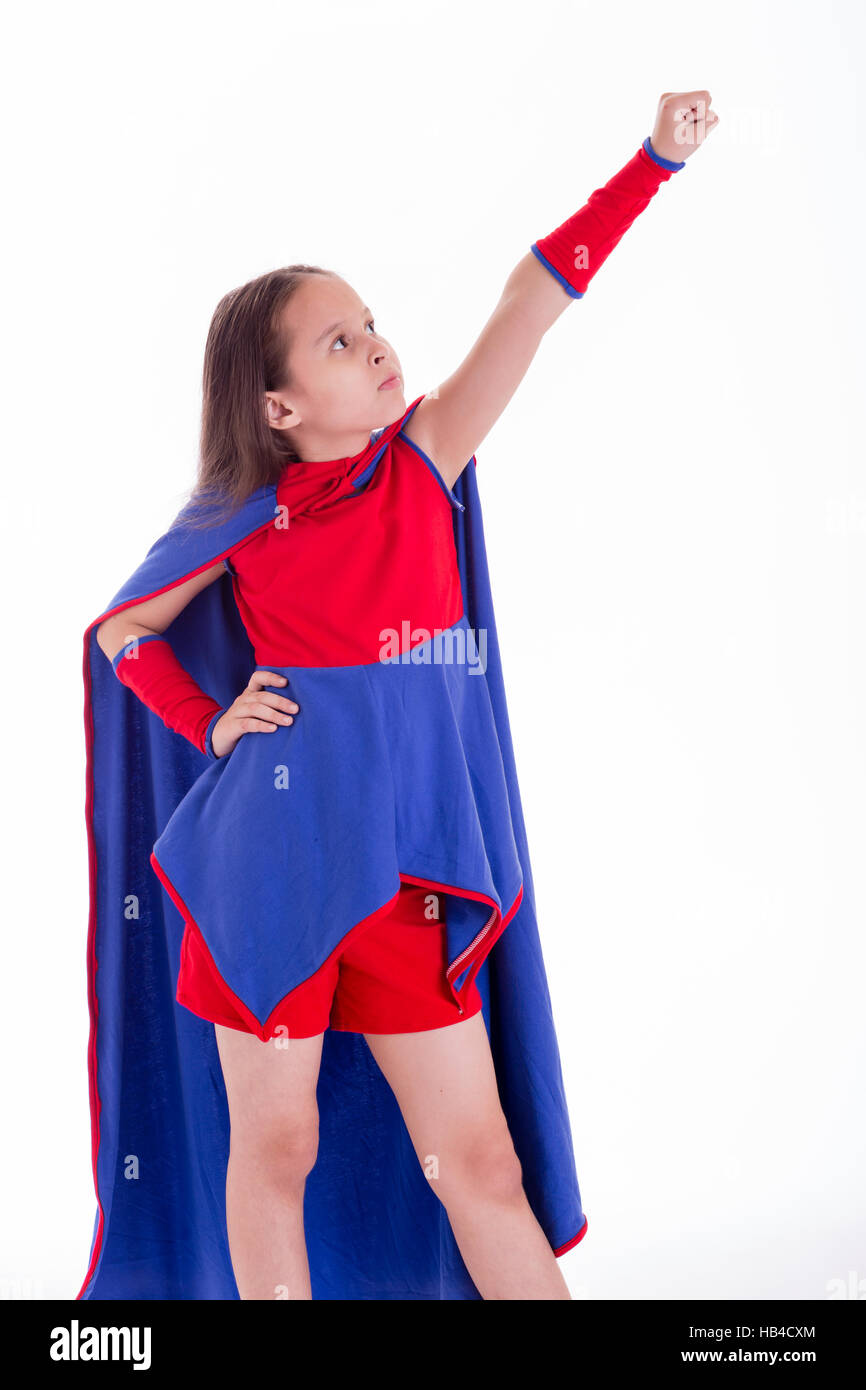 Girl in blue and red superhero costume holding arm up Stock Photo - Alamy