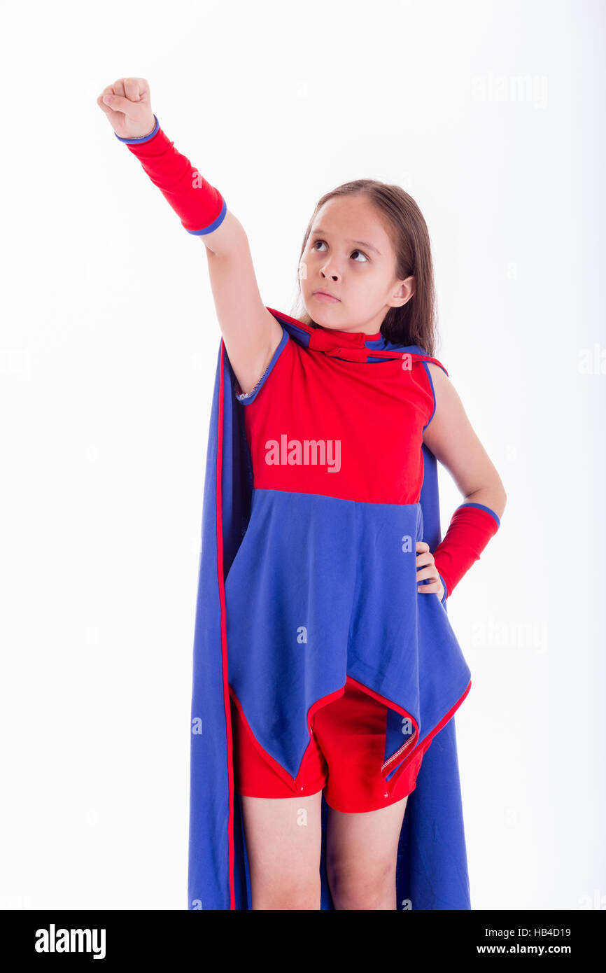 Girl in blue and red superhero costume holding arm up Stock Photo - Alamy