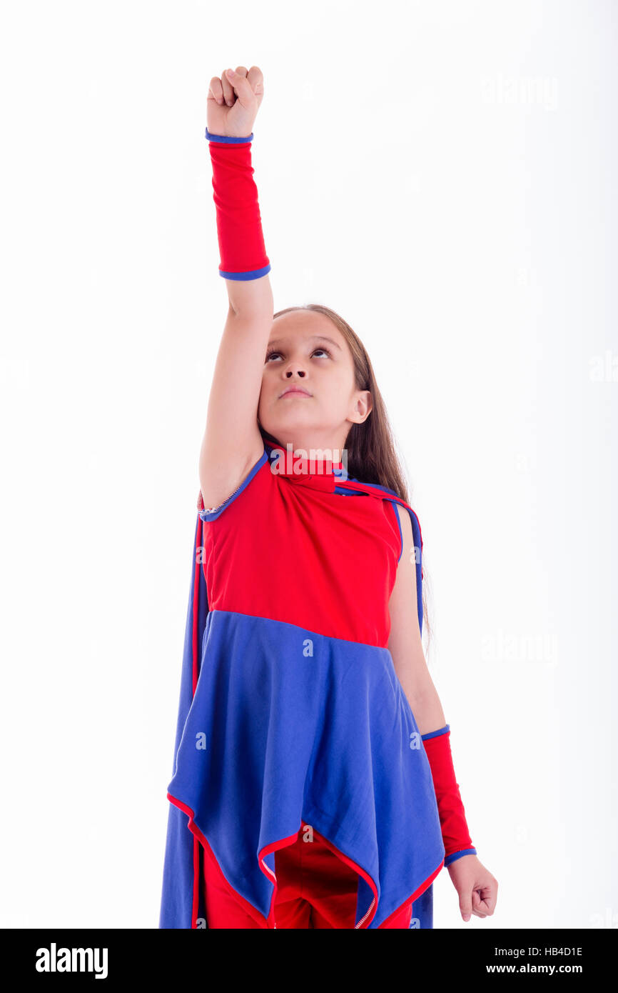 Girl in blue and red superhero costume holding arm up Stock Photo - Alamy