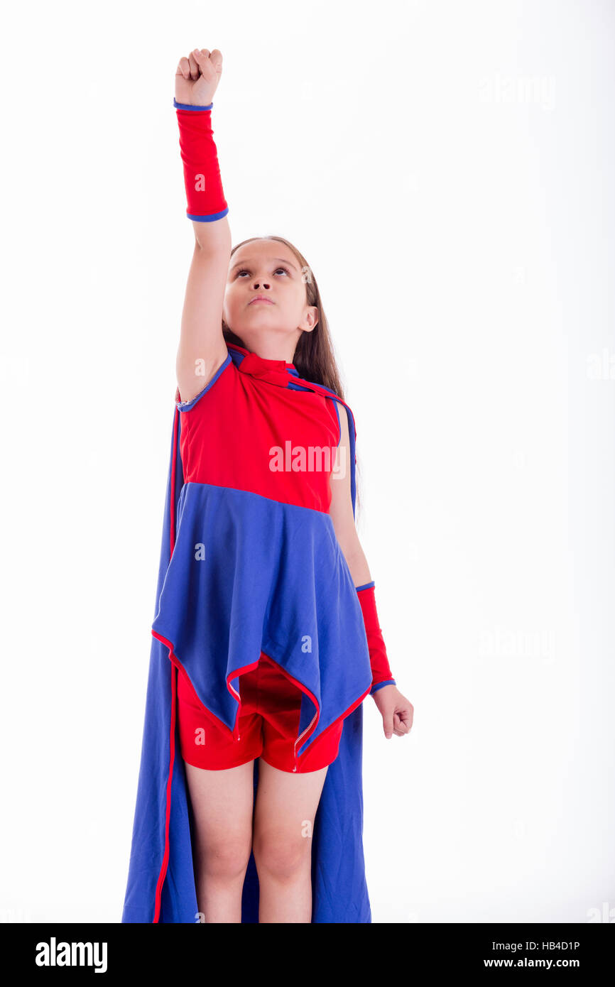Girl in blue and red superhero costume holding arm up Stock Photo - Alamy