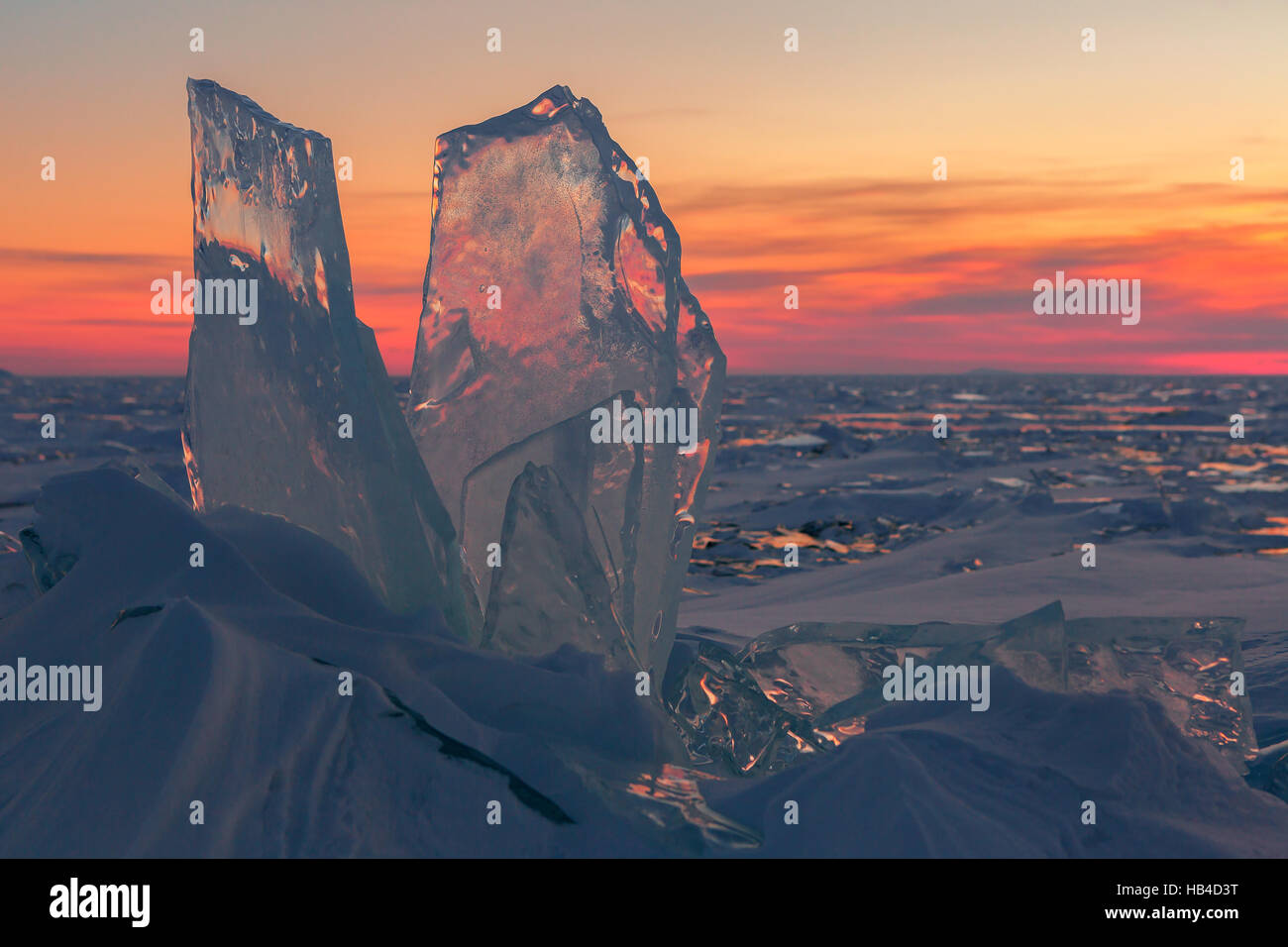 Transparent ice on sunset sky background Stock Photo - Alamy