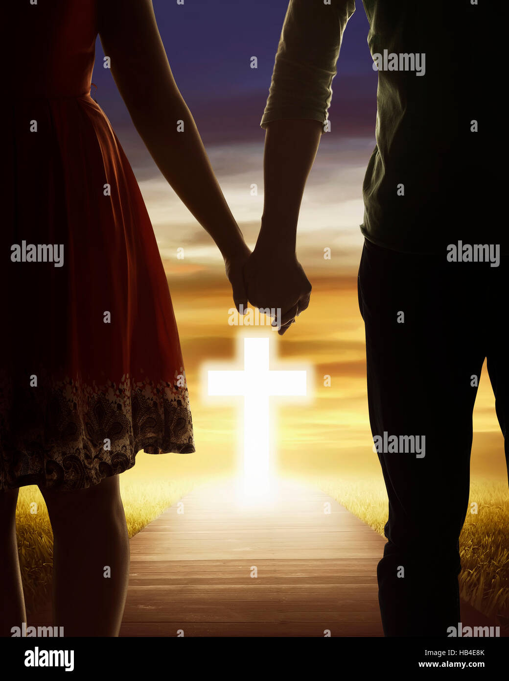Young couple looking the shining cross. Religious concept Stock Photo ...