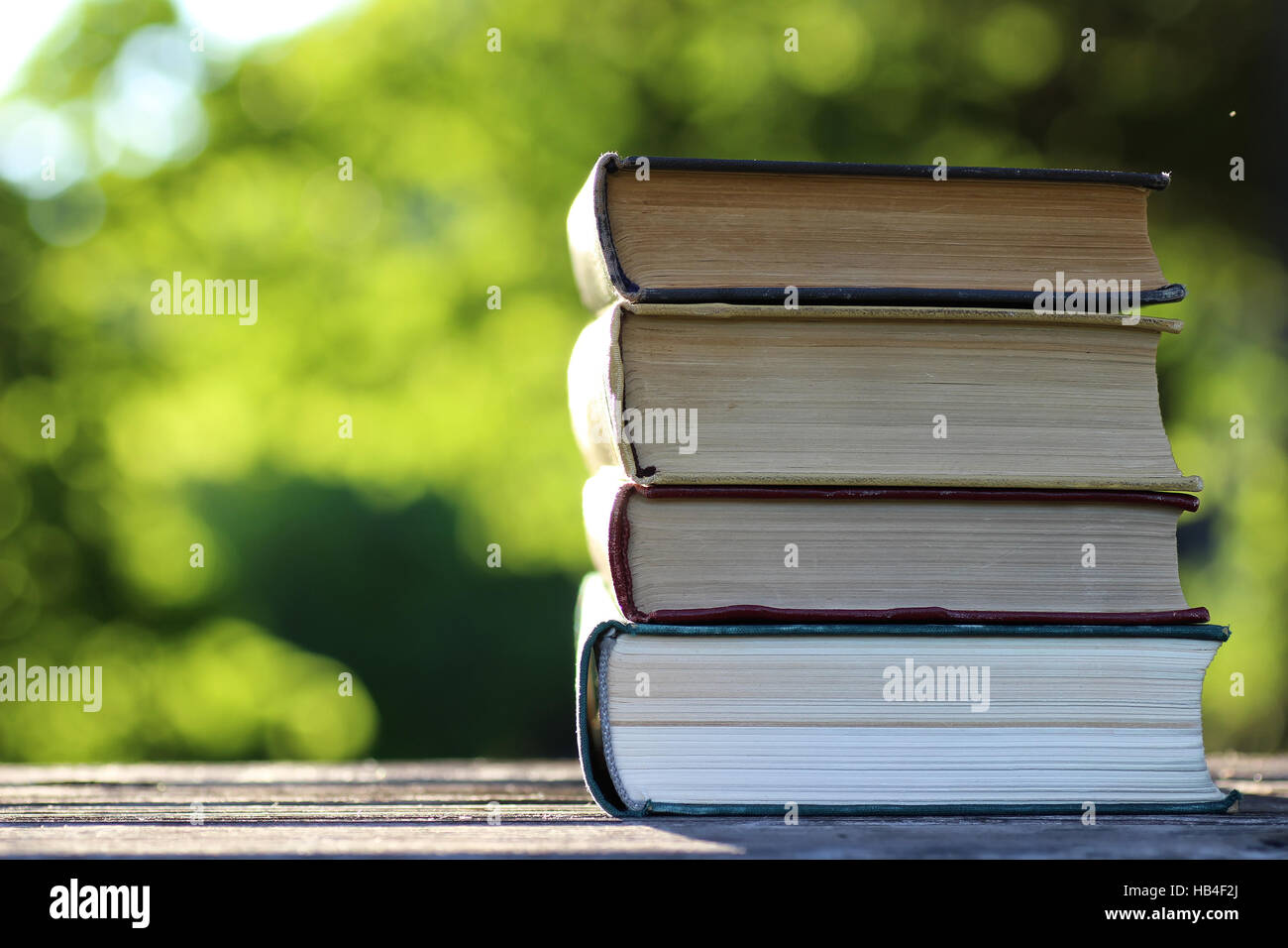 book stack background table wooden outdoor Stock Photo - Alamy