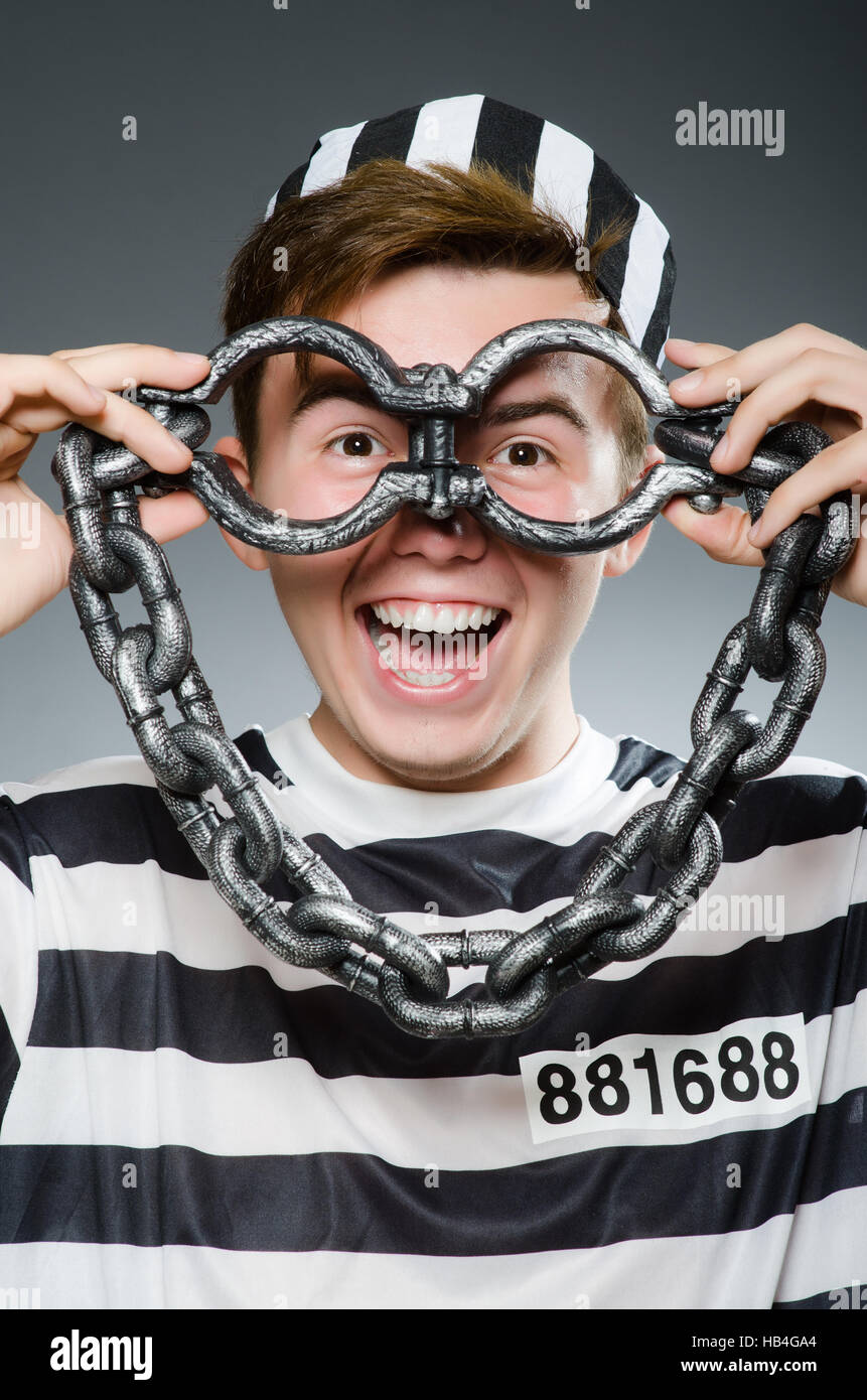 Funny prisoner in prison concept Stock Photo - Alamy
