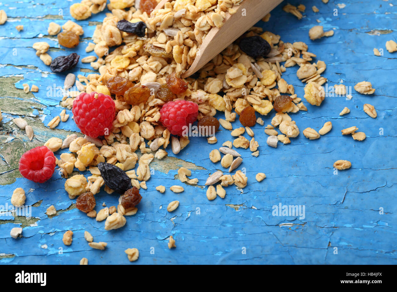 Fruits granola on rustic blue background, food closeup Stock Photo - Alamy
