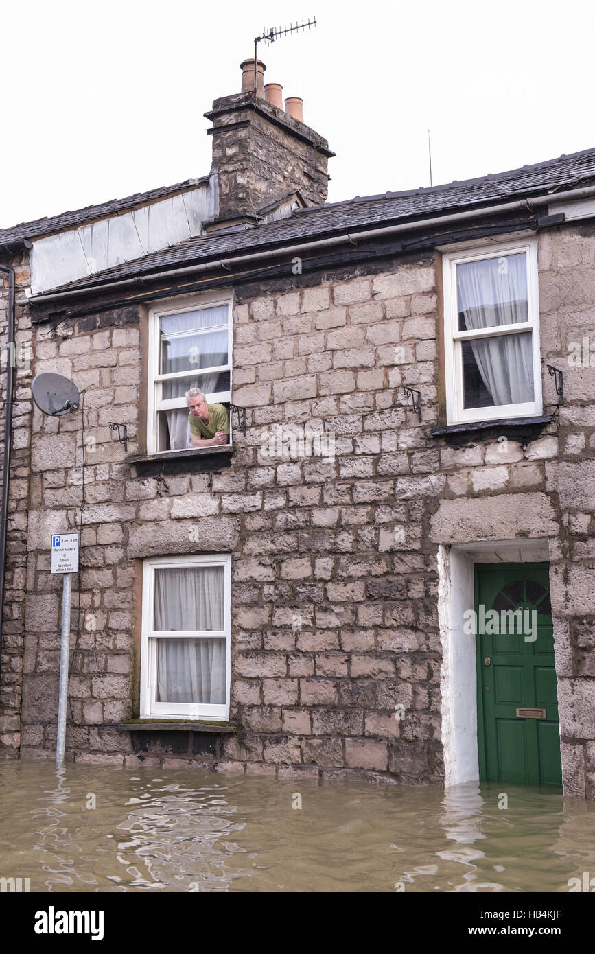 A man looks out of his window as he is stranded inside his home due to ...