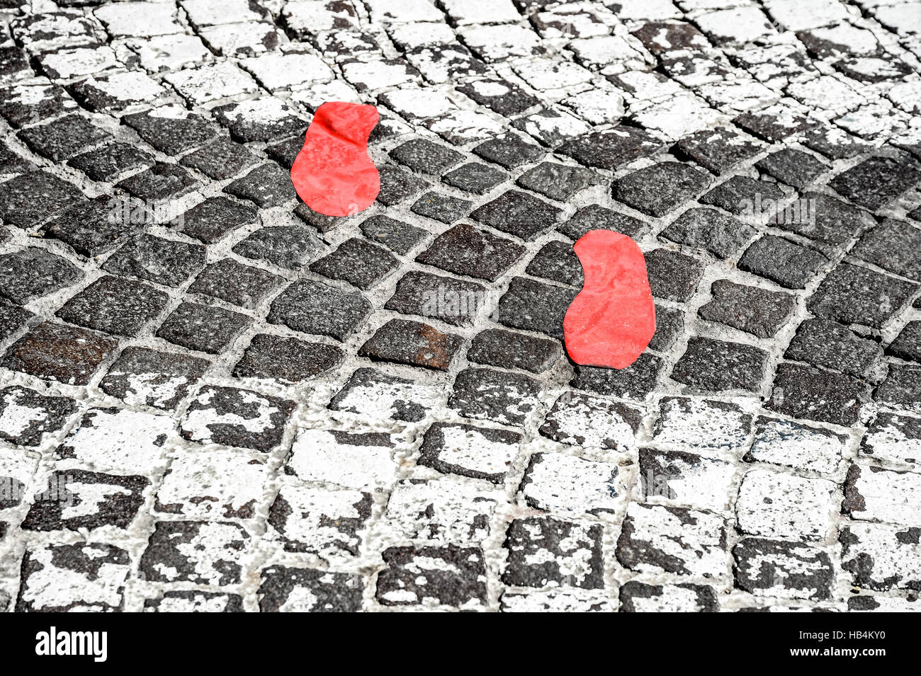 Red footsteps in town Stock Photo - Alamy