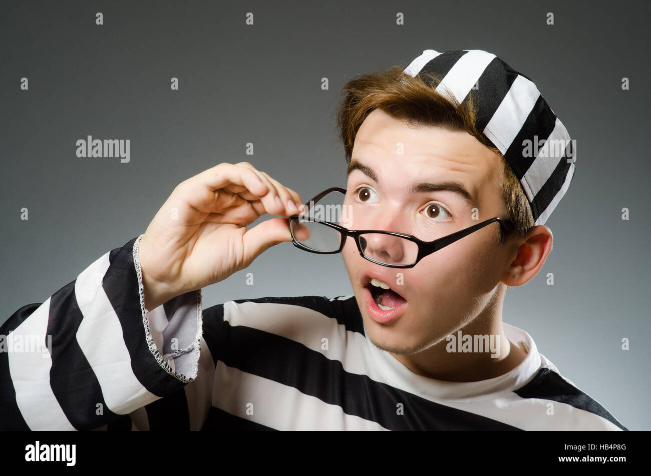 Funny prisoner in prison concept Stock Photo - Alamy