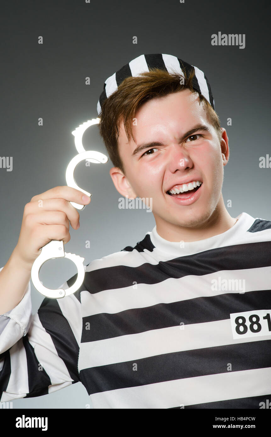 Funny prisoner in prison concept Stock Photo - Alamy