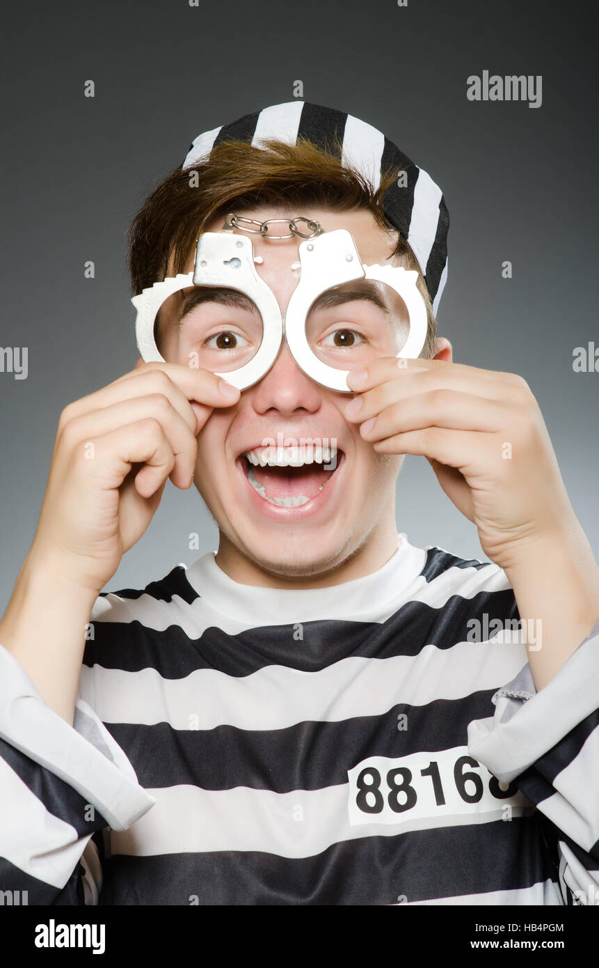 Funny prisoner in prison concept Stock Photo - Alamy