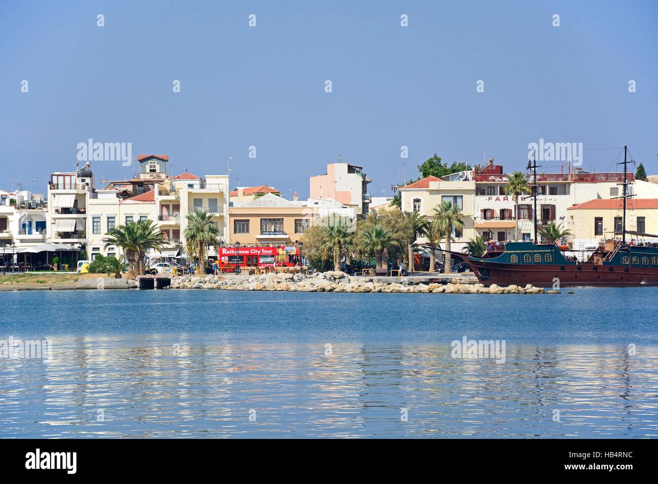 View of the waterfront buildings with a galleon moored in the harbour ...
