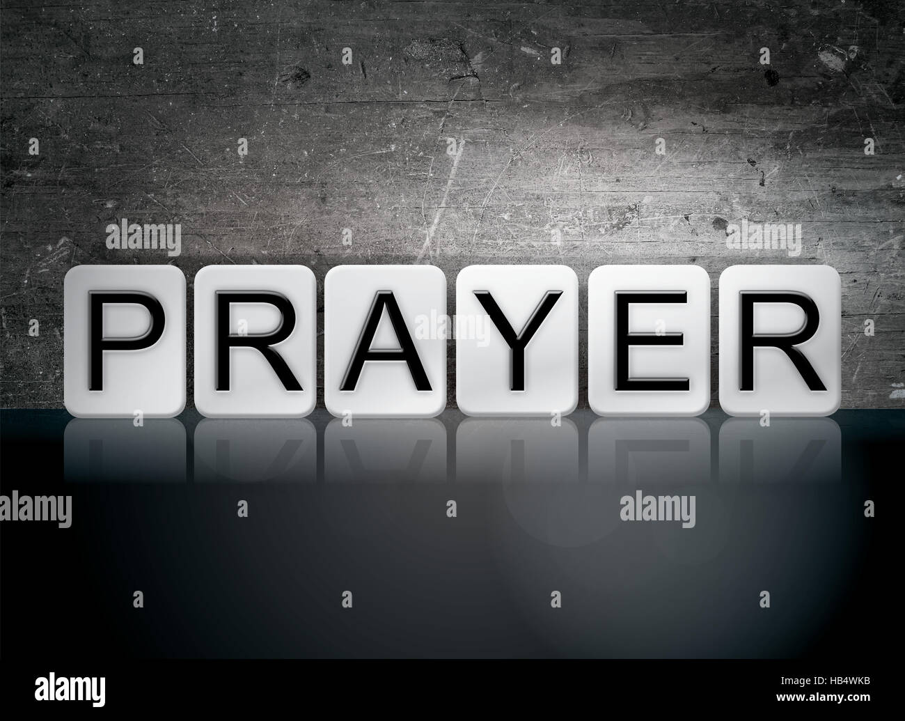 The word "Prayer" written in white tiles against a dark vintage grunge ...