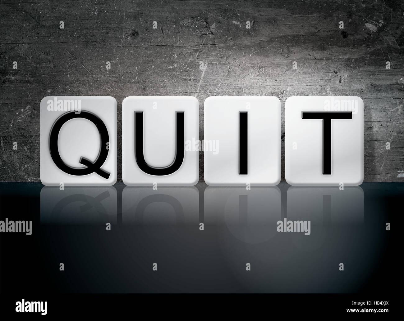 The word "Quit" written in white tiles against a dark vintage grunge ...