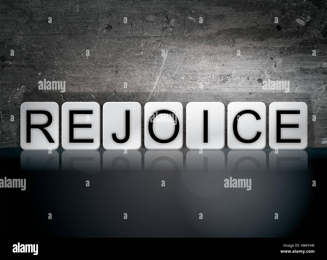 The word "Rejoice" written in white tiles against a dark vintage grunge ...