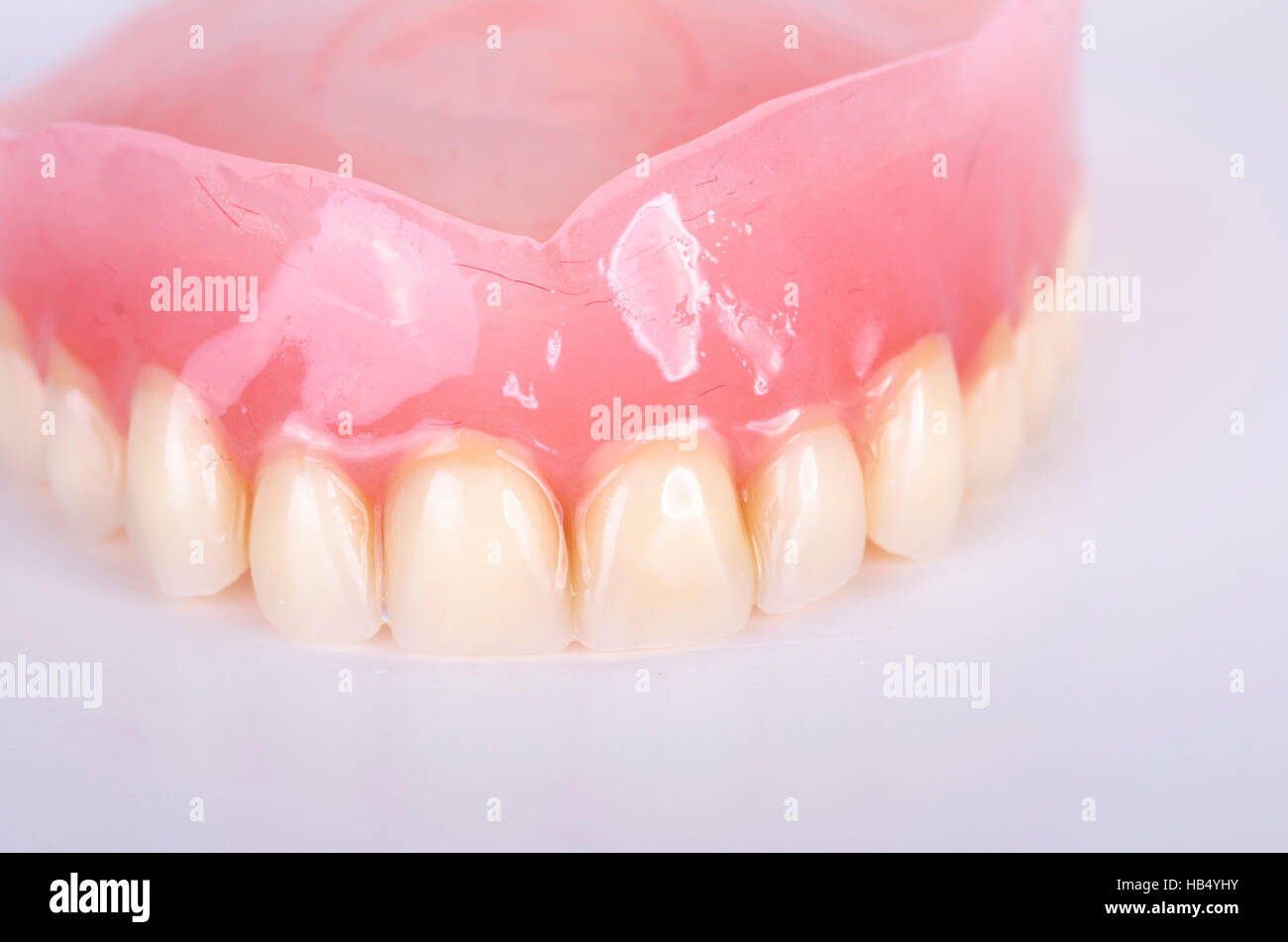 Photo of false teeth on white background Stock Photo - Alamy