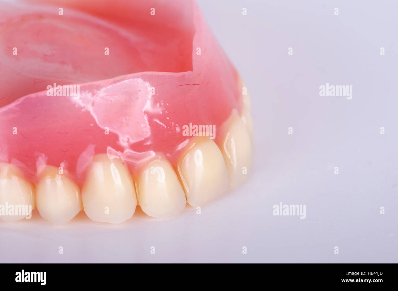 Photo of false teeth on white background Stock Photo - Alamy