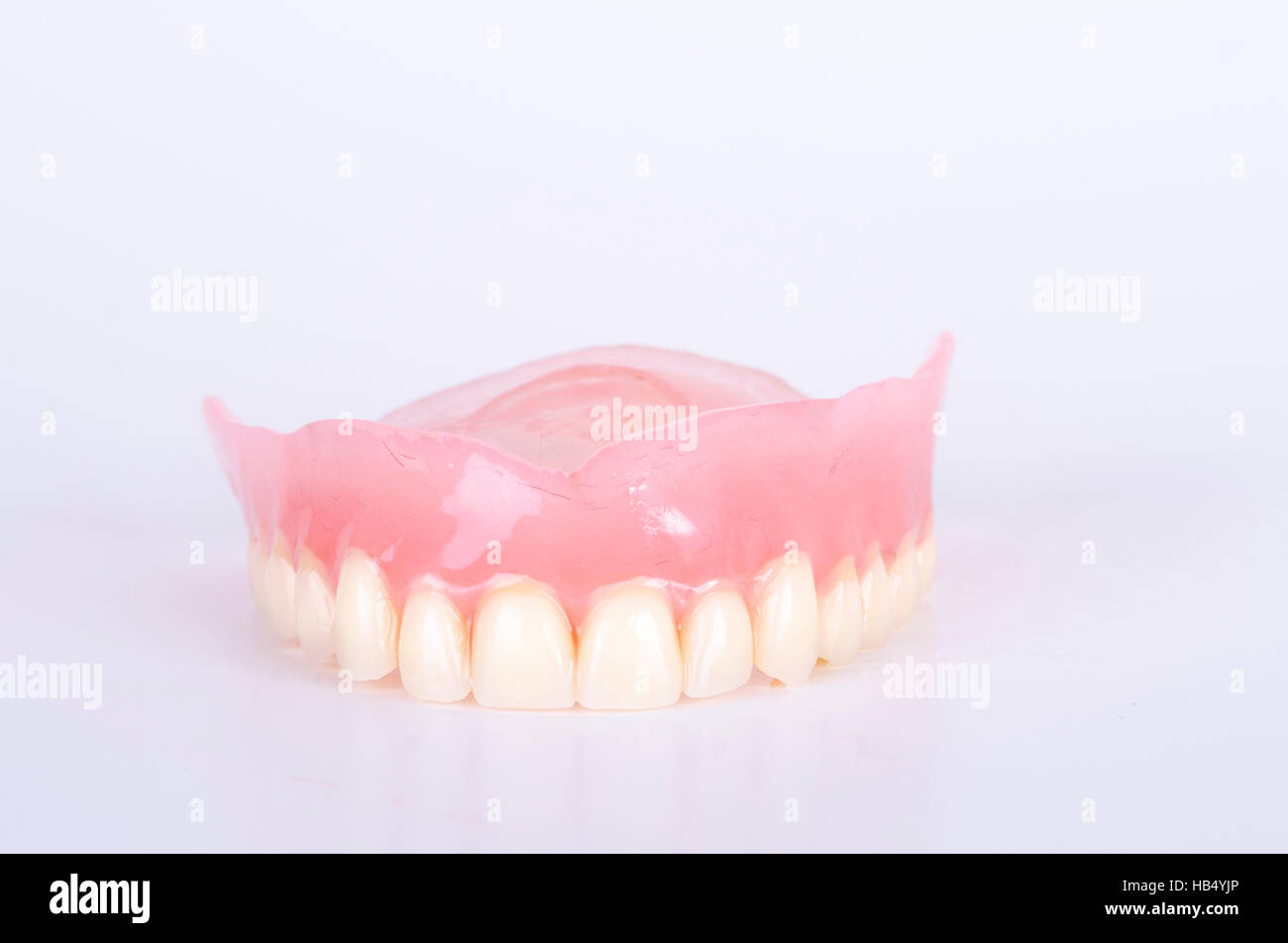 Photo of false teeth on white background Stock Photo - Alamy