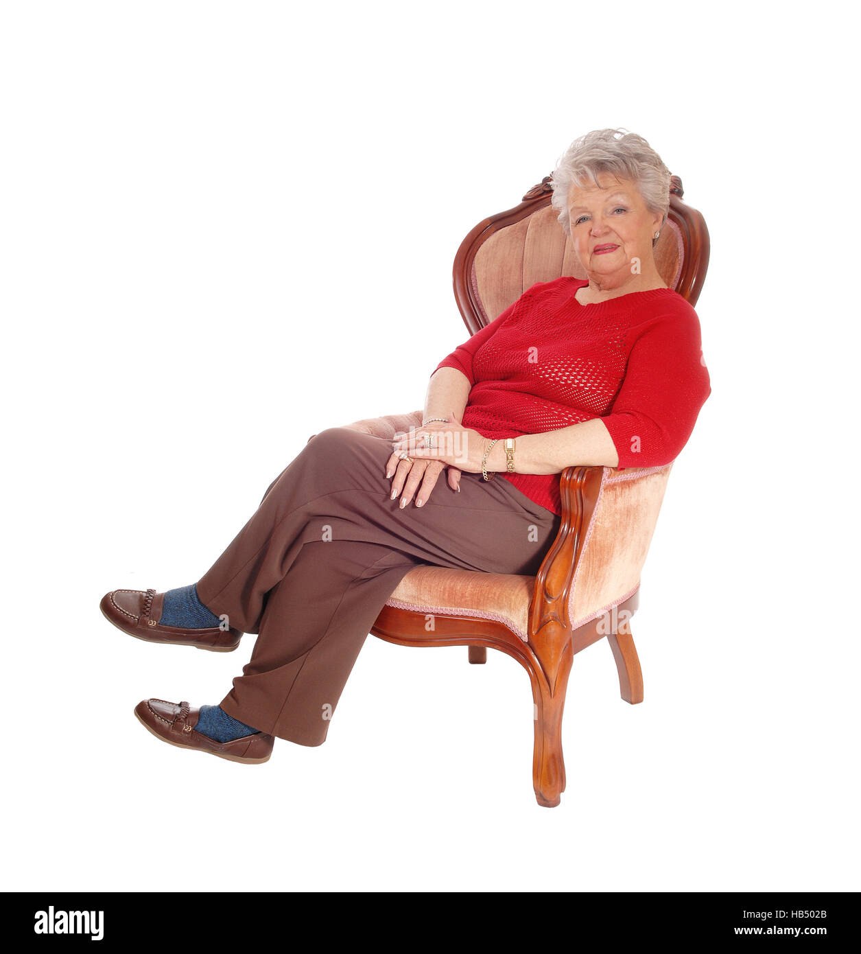 Senior lady resting in armchair Stock Photo - Alamy