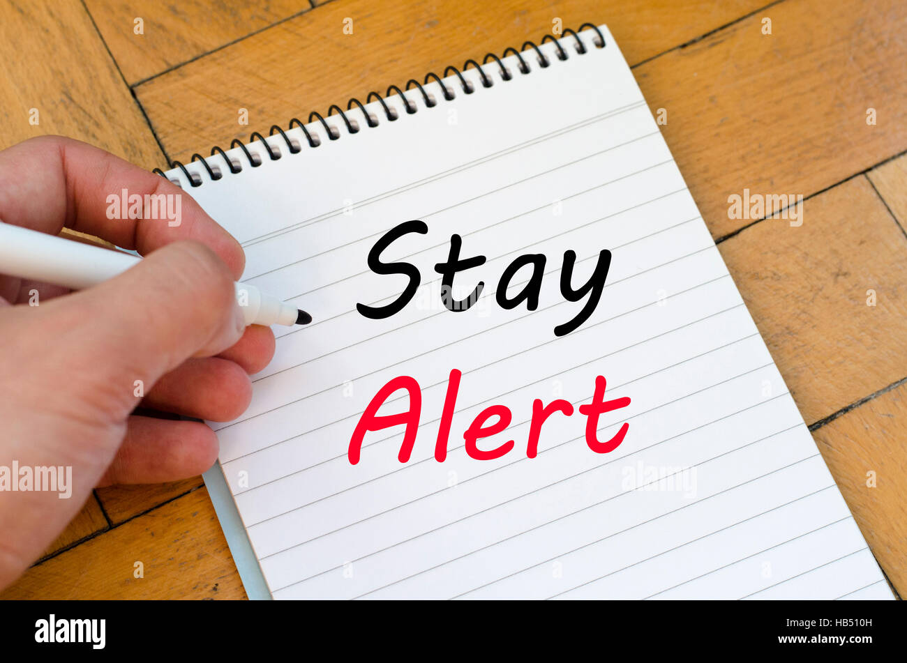Stay alert text concept write on notebook Stock Photo - Alamy