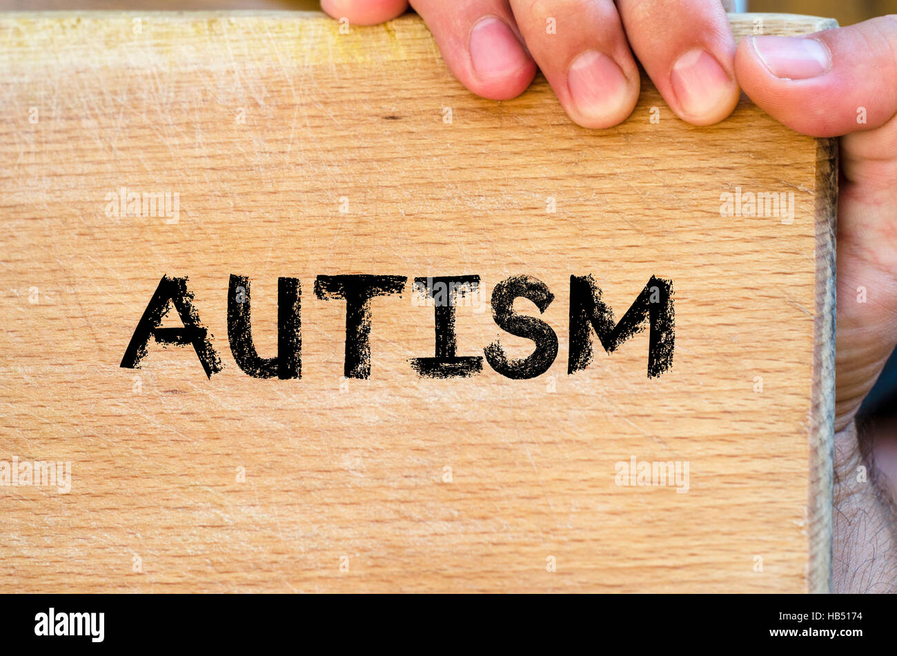 Human hand over wooden background and autism text concept Stock Photo ...
