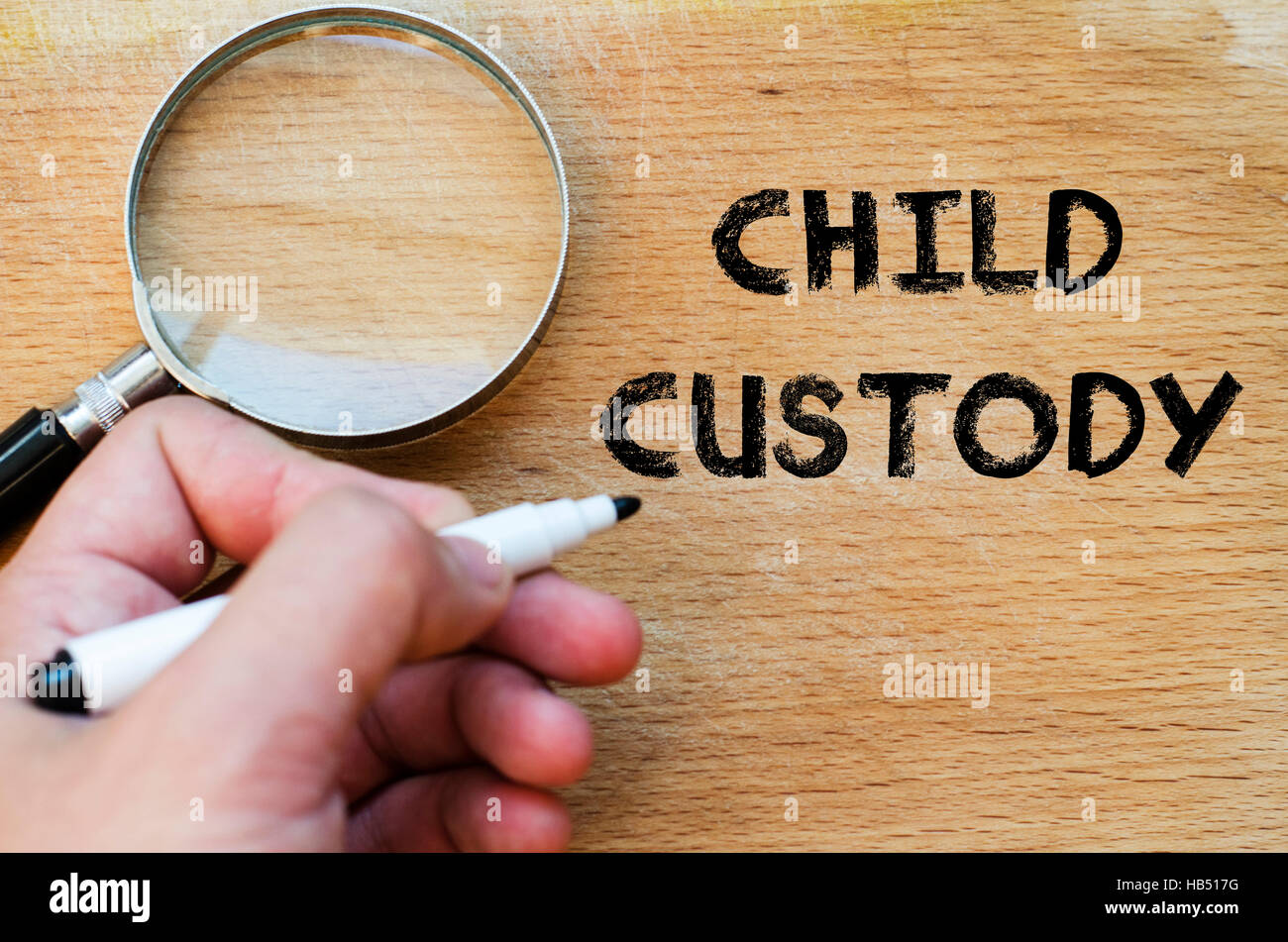 Human hand over wooden background and child custody text concept Stock ...