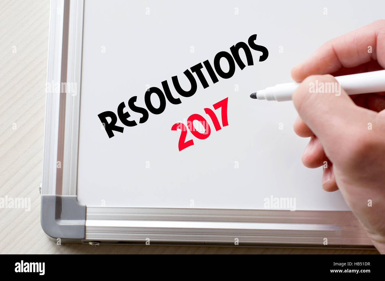 Human hand writing resolutions 2017 on whiteboard Stock Photo - Alamy