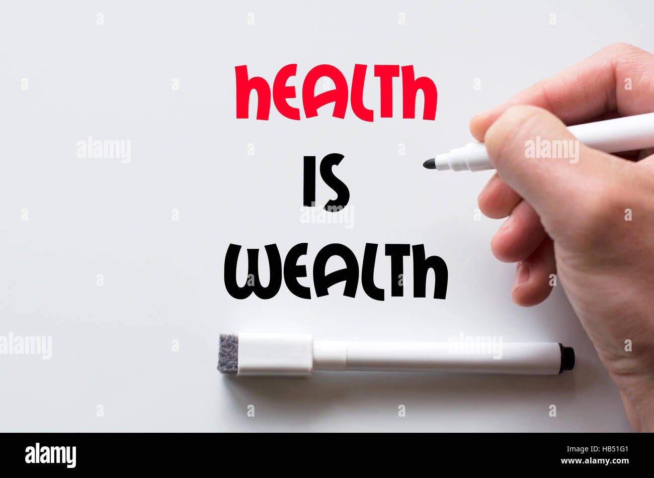 Human hand writing health is wealth on whiteboard Stock Photo - Alamy