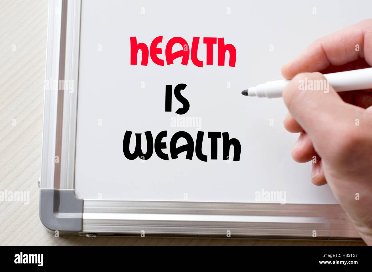 Human hand writing health is wealth on whiteboard Stock Photo - Alamy