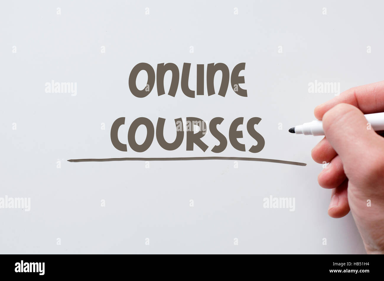 Human hand writing online courses on whiteboard Stock Photo - Alamy
