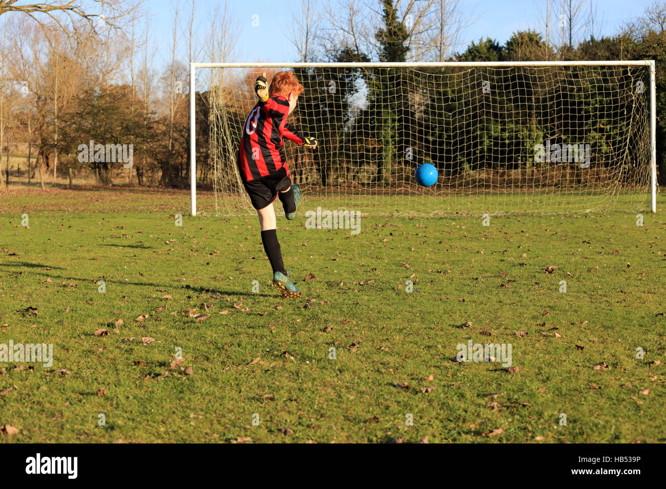 English school boy practicing penalty kick Stock Photo - Alamy