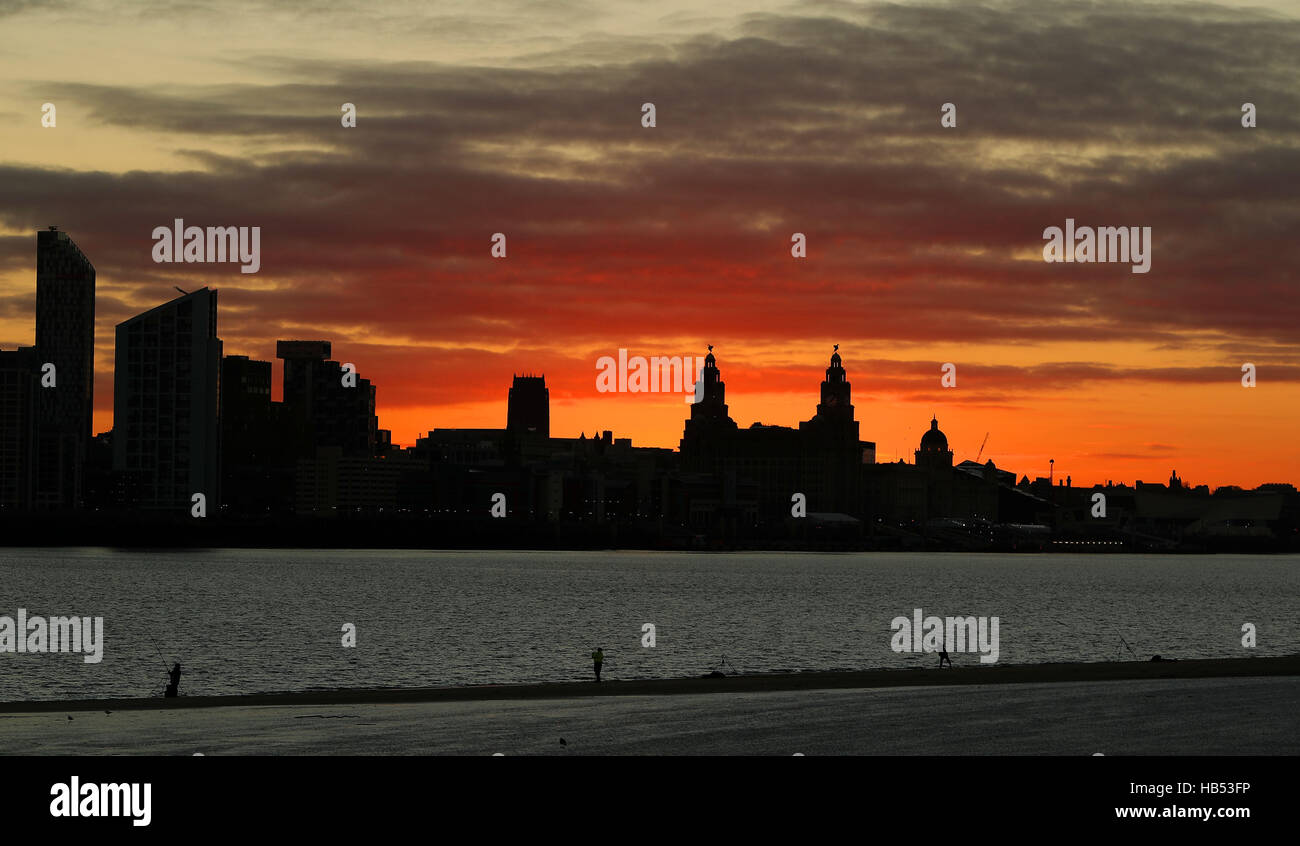 The sun rises behind liver building over liverpool waterfront hi-res ...