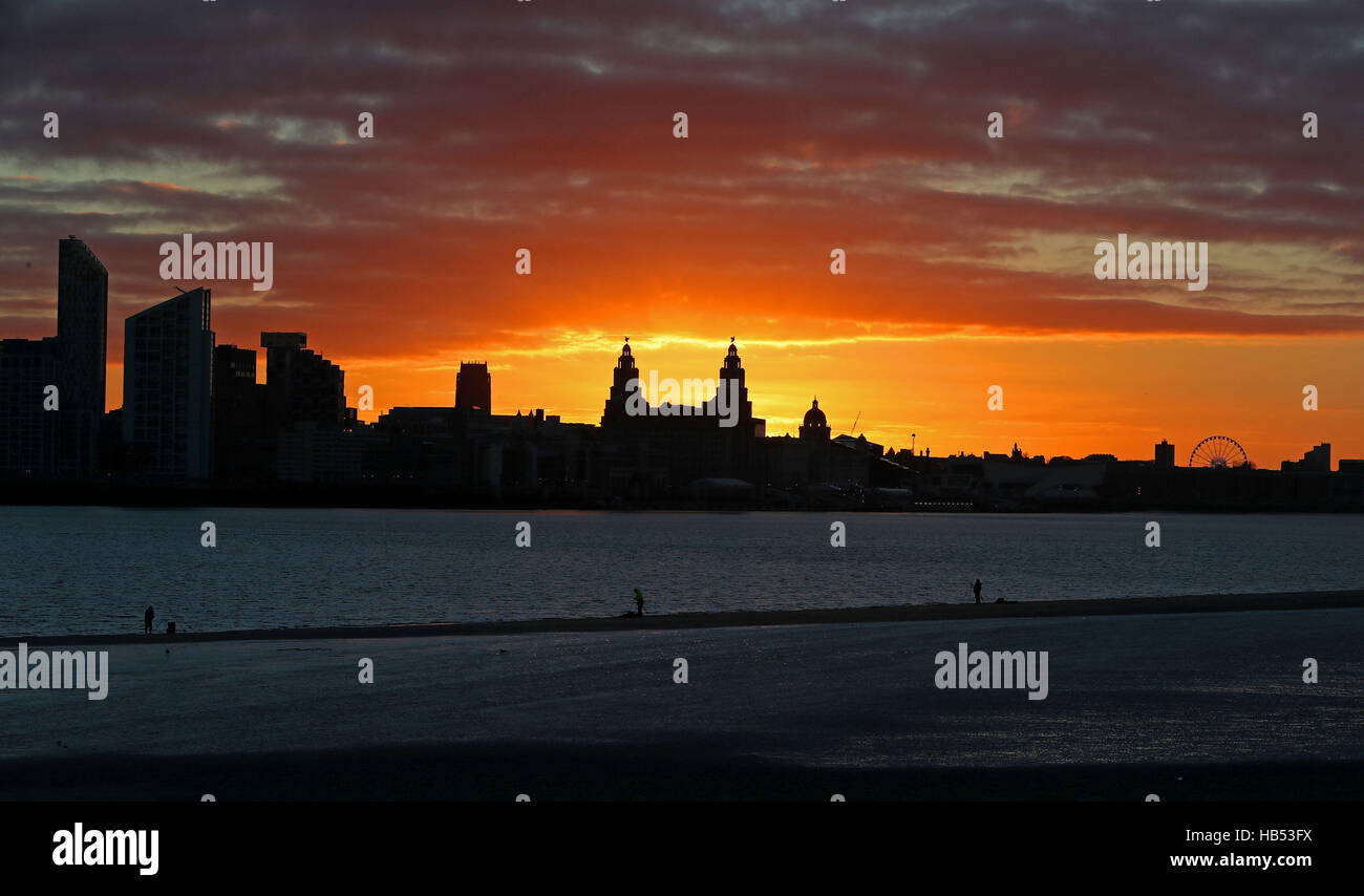 The sun rises behind the Liver Building over the Liverpool waterfront ...