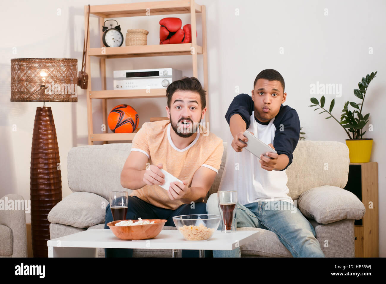 Happy friends playing computer games Stock Photo - Alamy