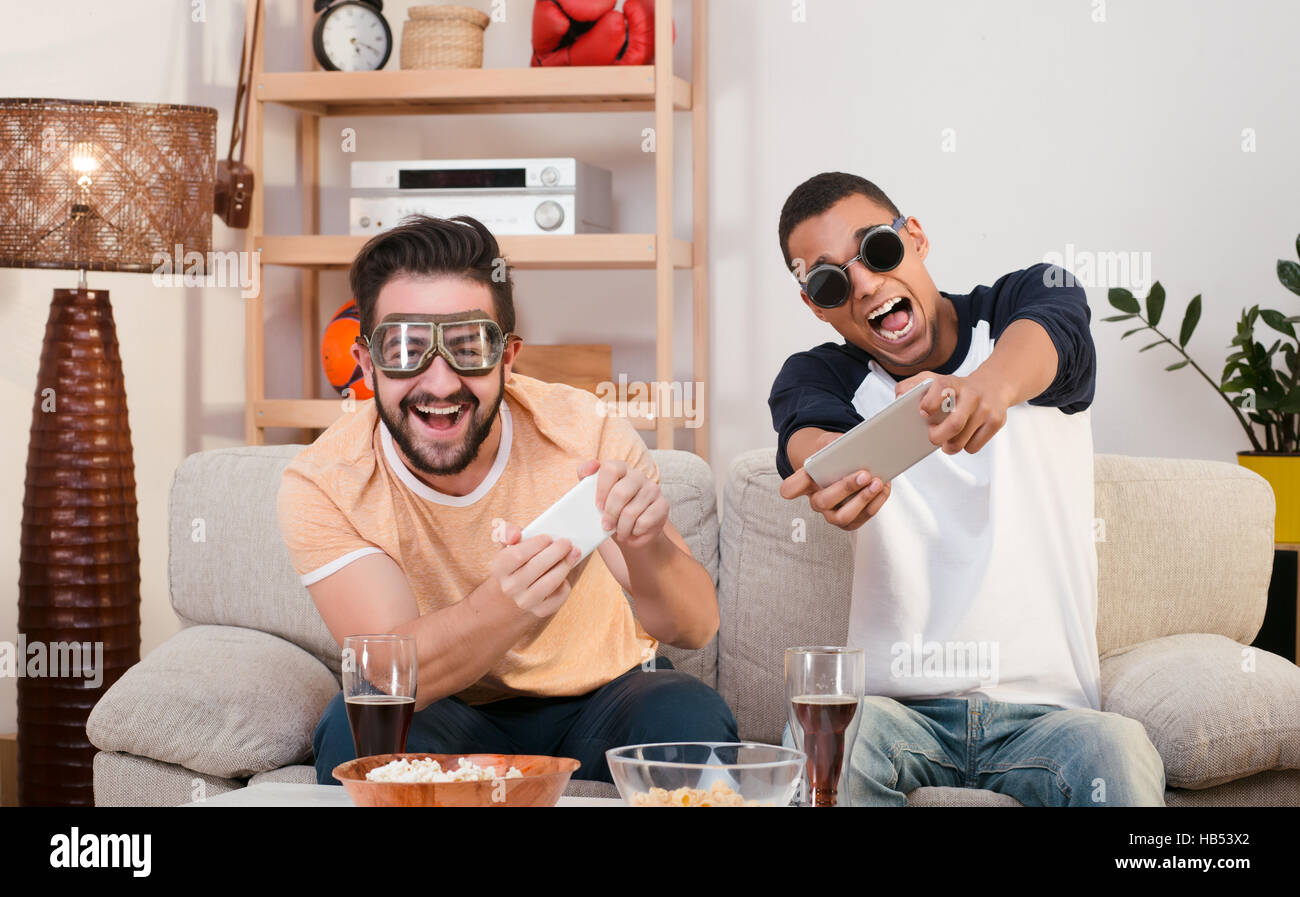 Happy friends playing computer games Stock Photo - Alamy