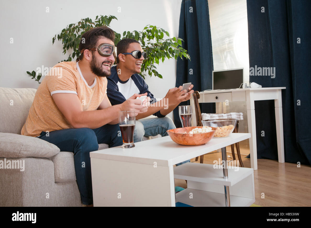 Happy friends playing computer games Stock Photo - Alamy