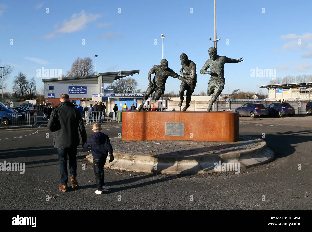 Fans walk past the statue dedicated to Tameside's World Cup winners Sir ...