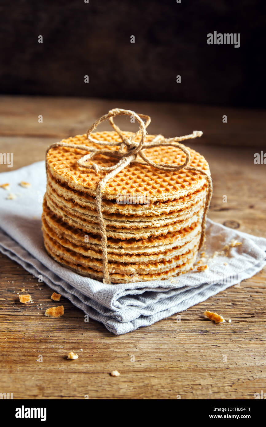 Stack of traditional dutch caramel waffles tied up with jute twine on ...