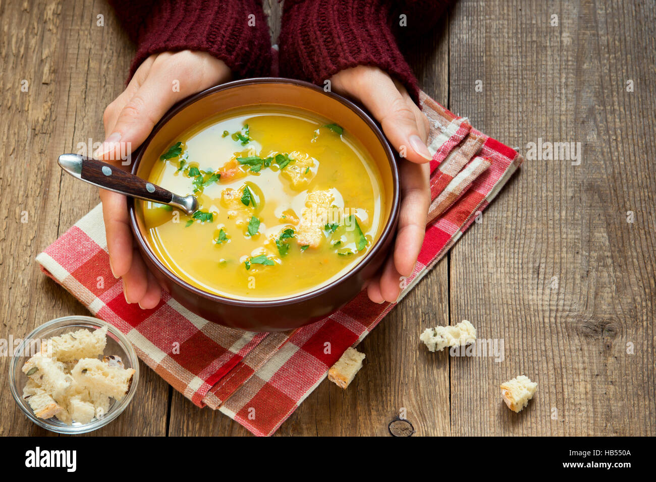 Woman hands holding bowl of vegetable soup with parsley and croutons ...