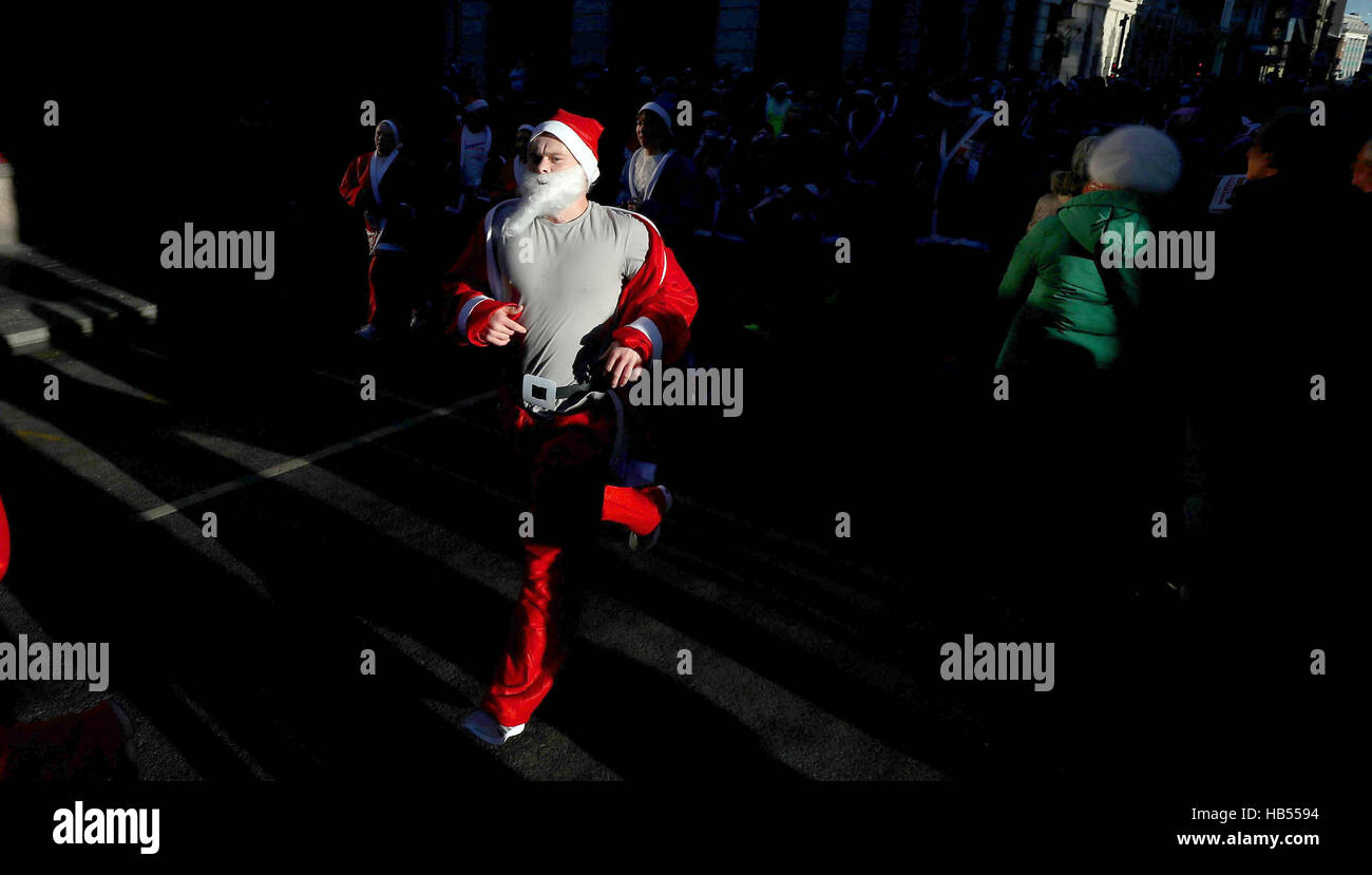 A runner dressed as Santa Claus makes his way around a 5k course at the ...