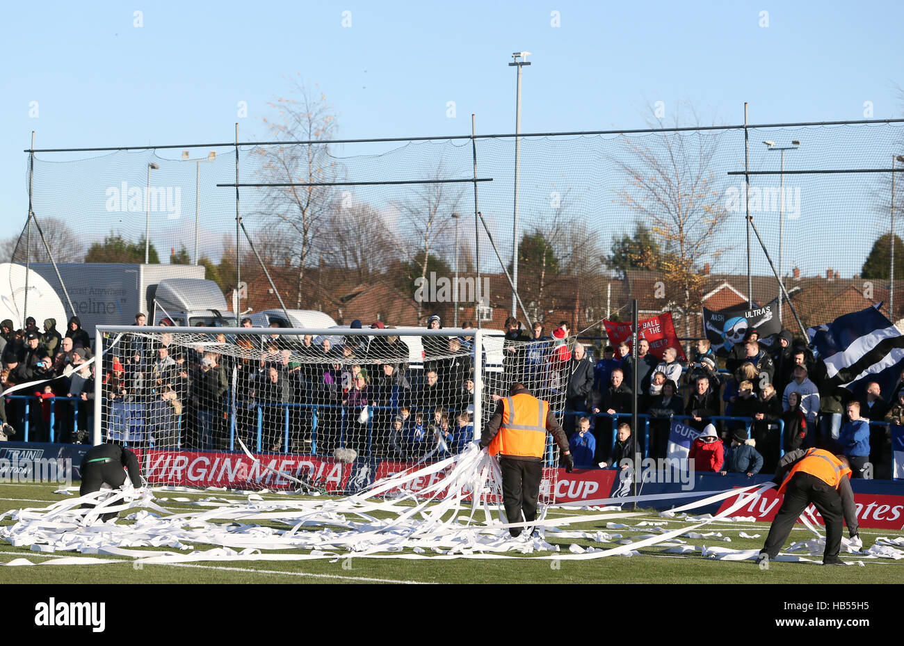 Stewards clean up paper from the pitch before the Emirates FA Cup match ...