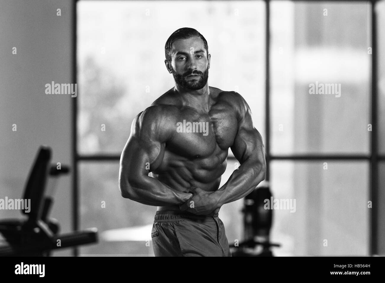 Young Italian Man Standing Strong In The Gym And Flexing Muscles ...