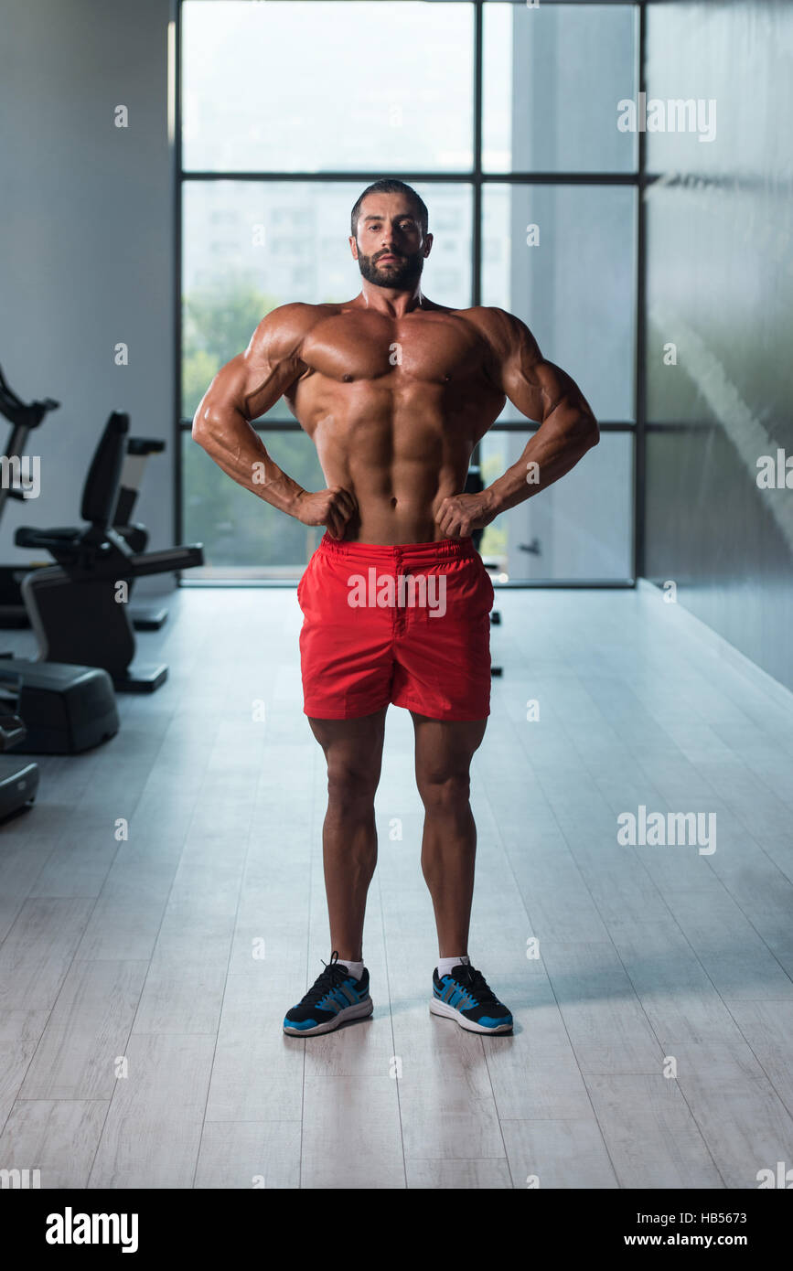 Young Italian Man Standing Strong In The Gym And Flexing Muscles ...