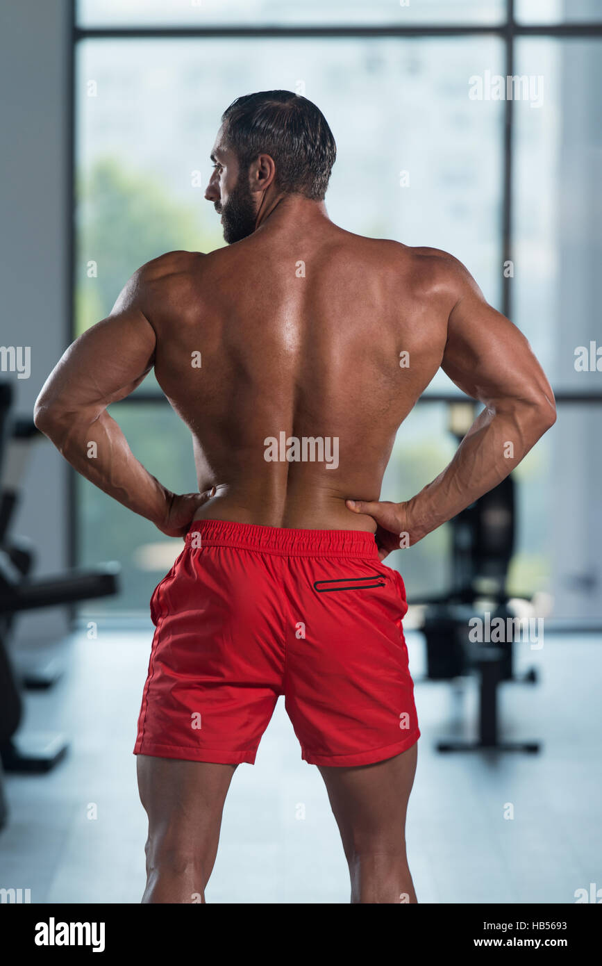 Young Italian Man Standing Strong In The Gym And Flexing Muscles ...