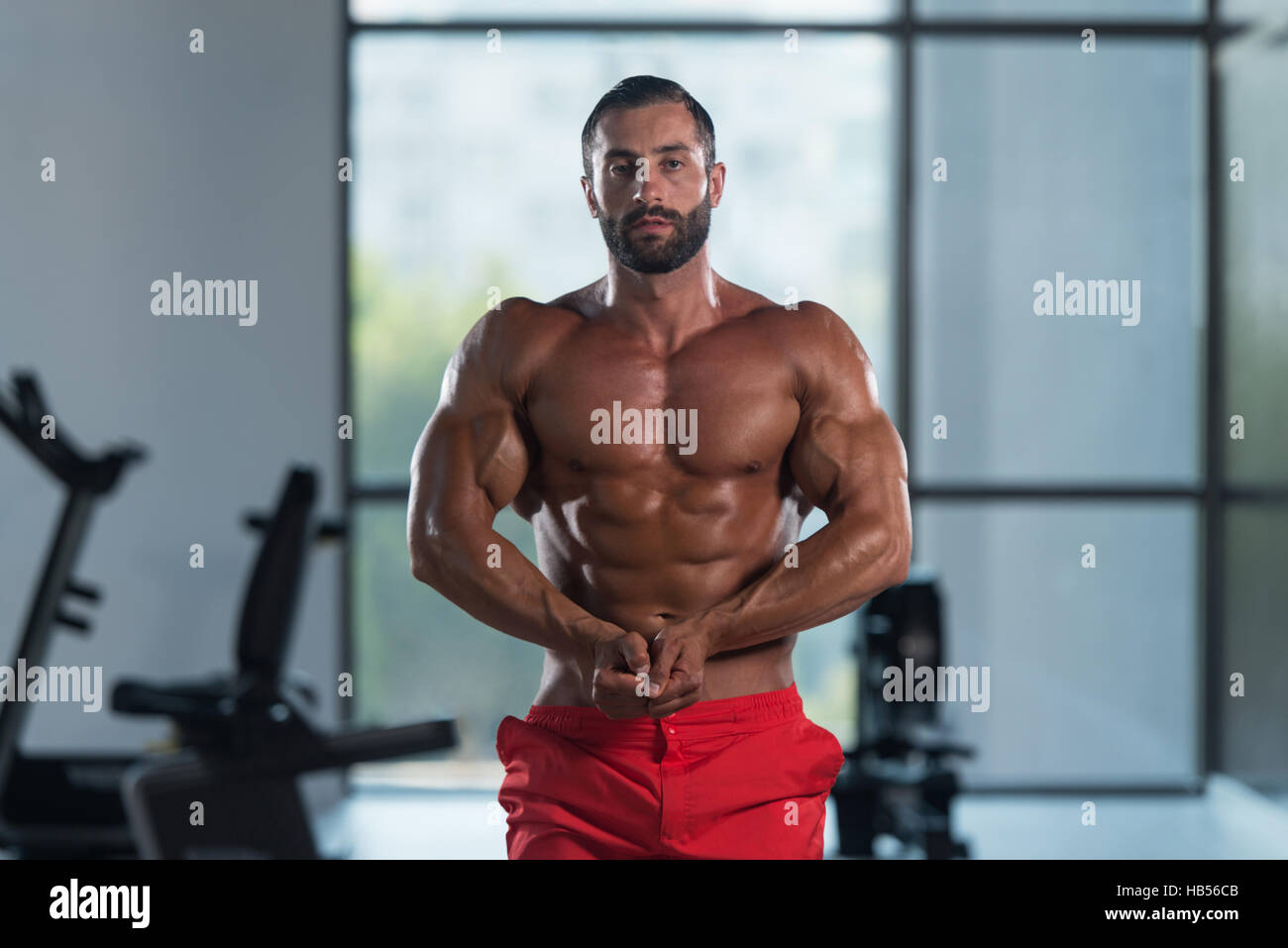 Young Italian Man Standing Strong In The Gym And Flexing Muscles ...