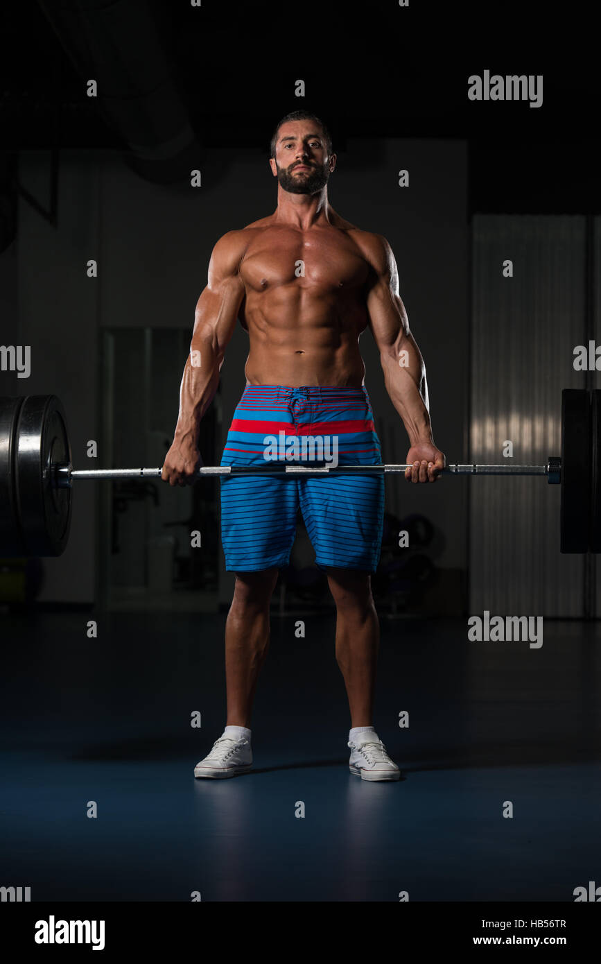 Latin Bodybuilder Doing Heavy Weight Exercise For Back With Barbell In ...