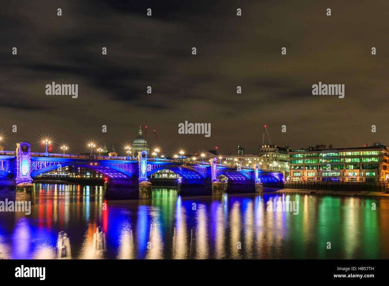 Southwark Bridge at night, illuminated, with the River Thames, London ...