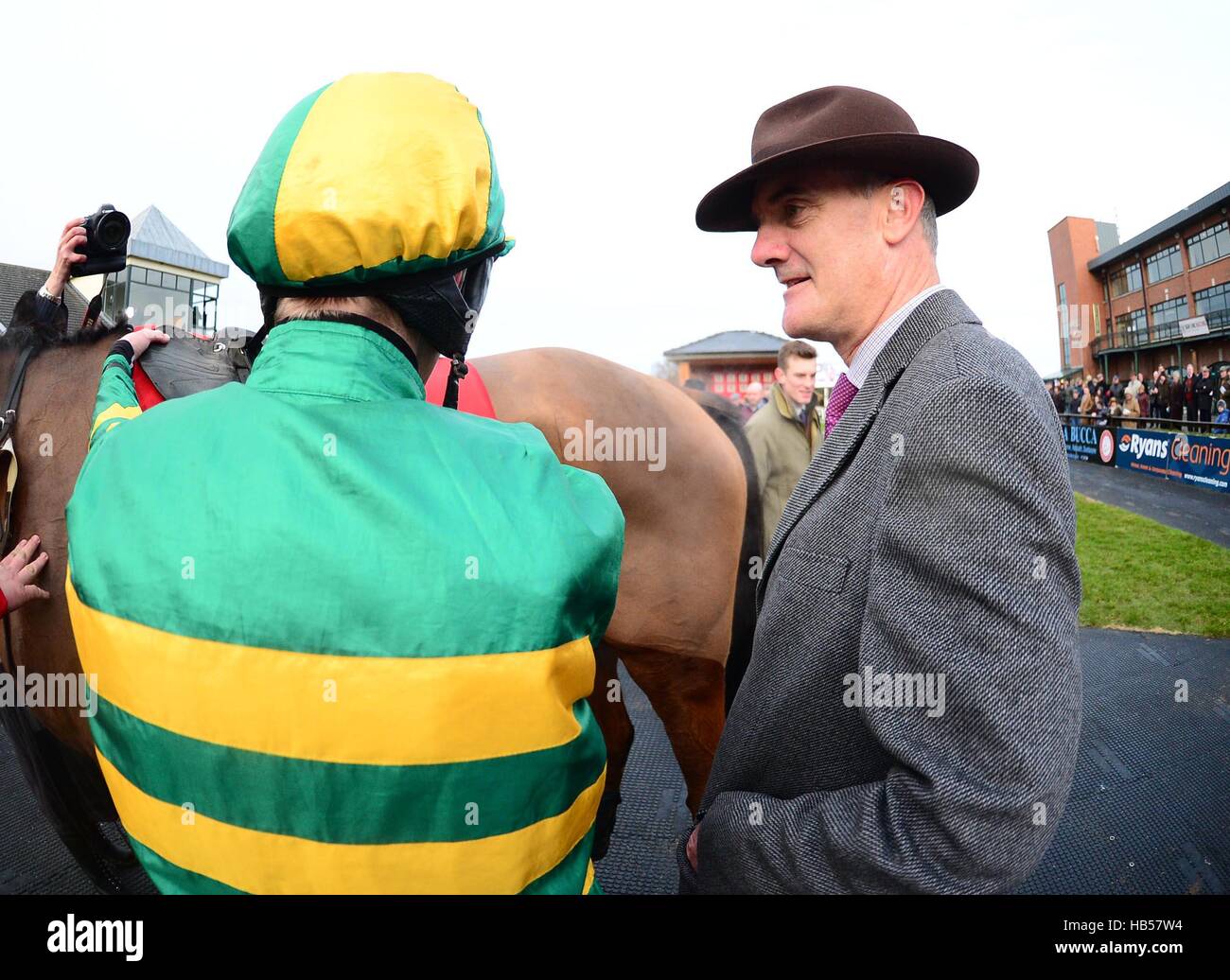 Trainer Edward Harty speaks with jockey Mark Walsh during day two of ...