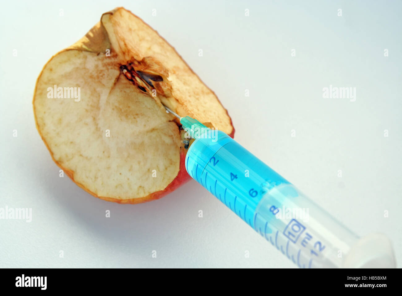 Laboratory test on a apple. Genetic modified food Stock Photo - Alamy